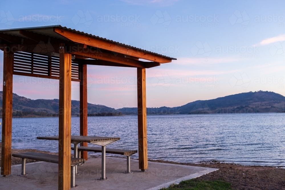 Image of Lakeside picnic bench seating and shelter at dusk with lake ...