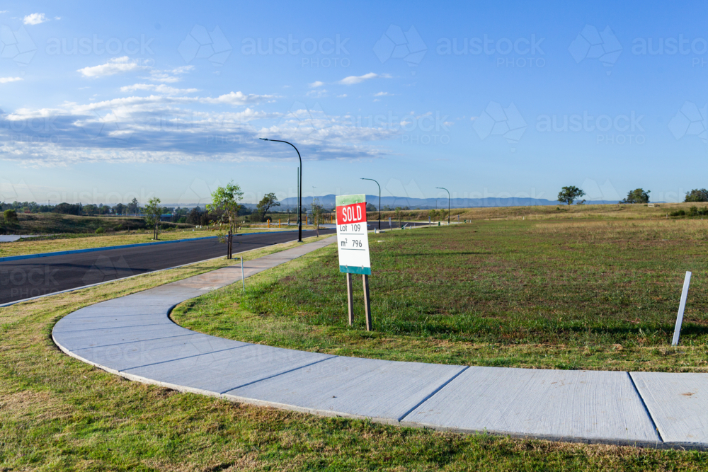 Image of Land sale sold sign on empty lot in housing development – The ...
