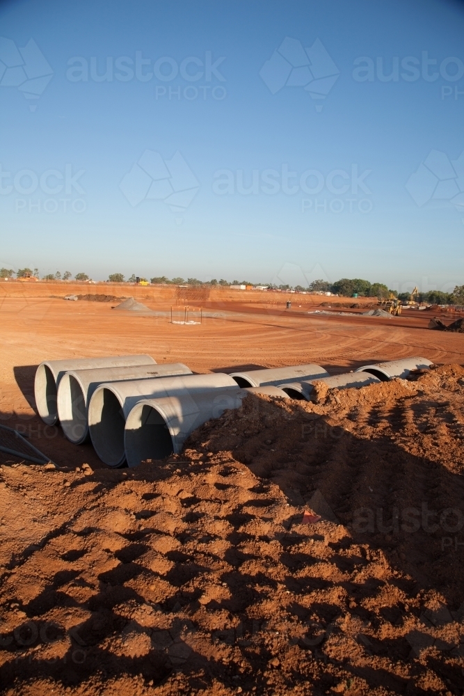 Image of Large cement pipes arranged on a large industrial building ...