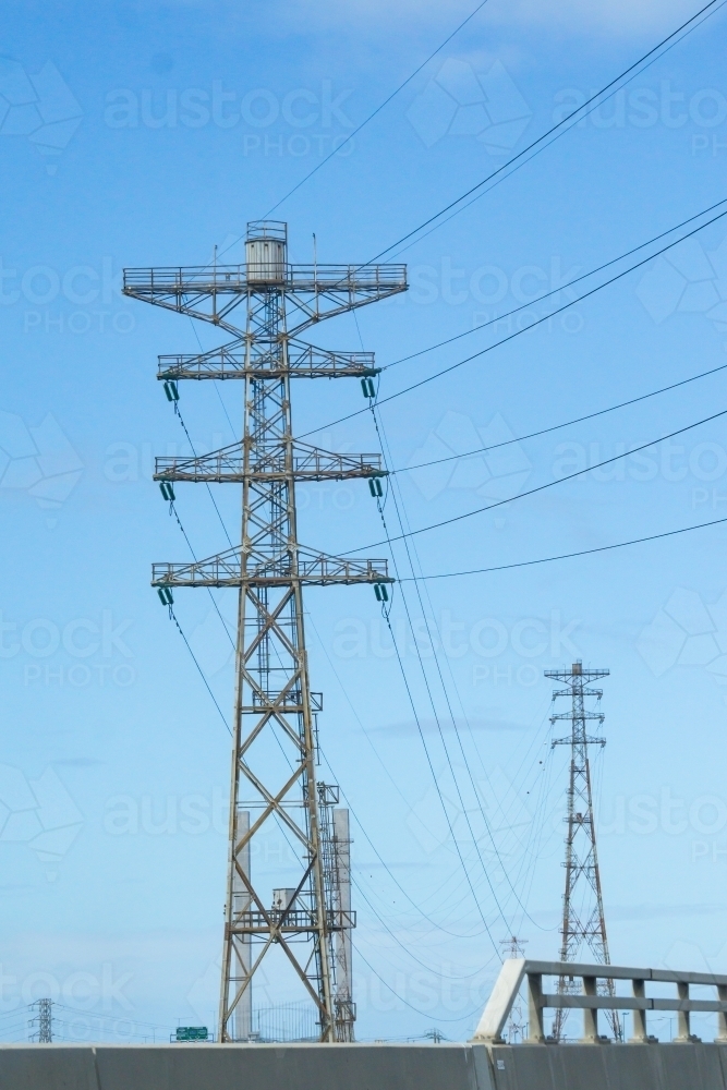 Image of Large electricity stanchions and power cables running over a ...
