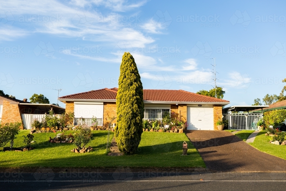 Image of Last light of the day shining on neat front garden and porch ...