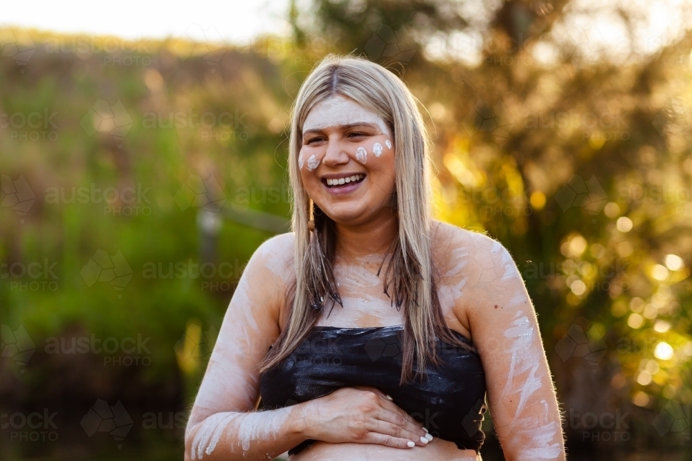 Image of laughing Aboriginal Australian woman in traditional ochre body ...