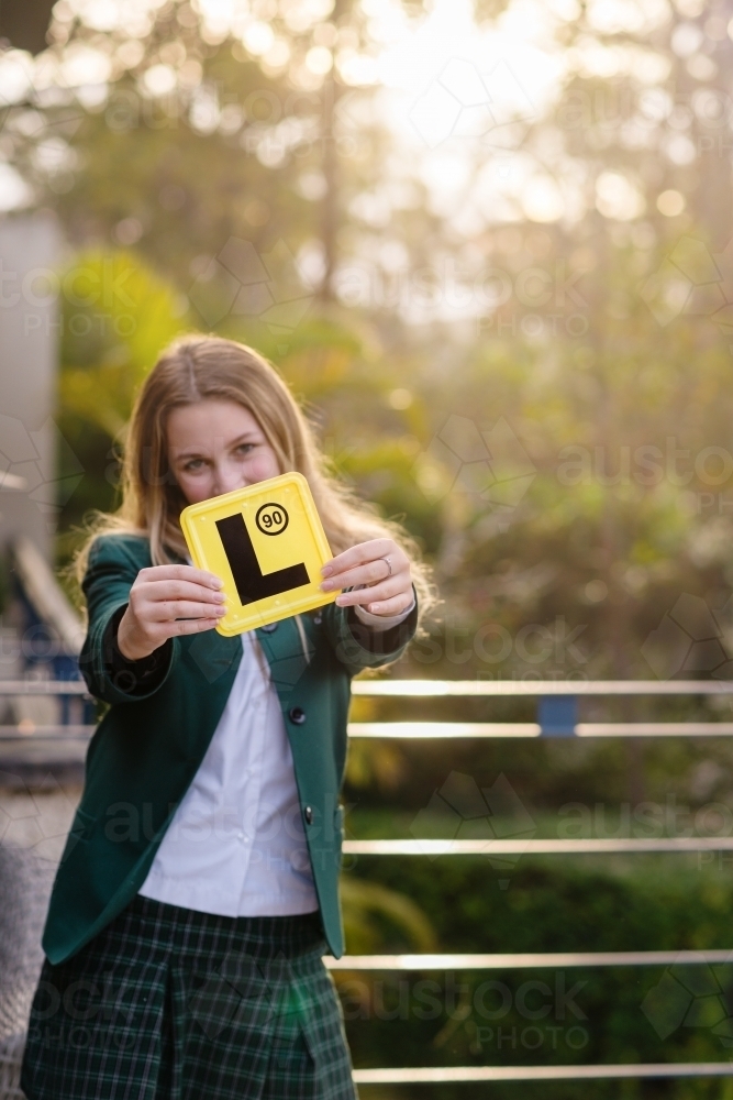 Image of learner driver with L plate - Austockphoto
