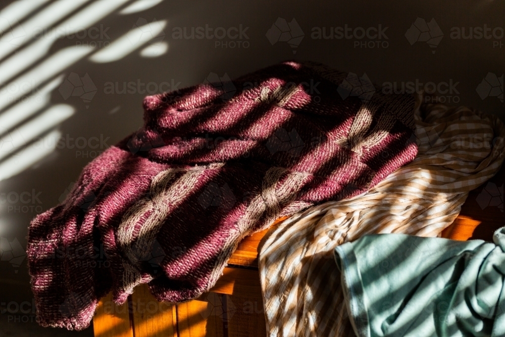Image of Light and shadow in bars falling on pastel coloured warm ...
