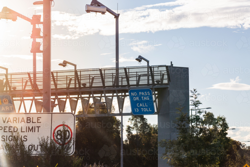 Image of Light flare over signage at toll road start point with e tag e ...