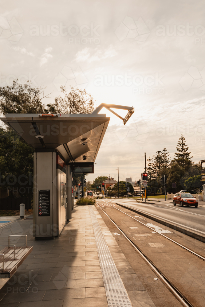 Image of Light rail stop at Newcastle Beach along road with cars ...