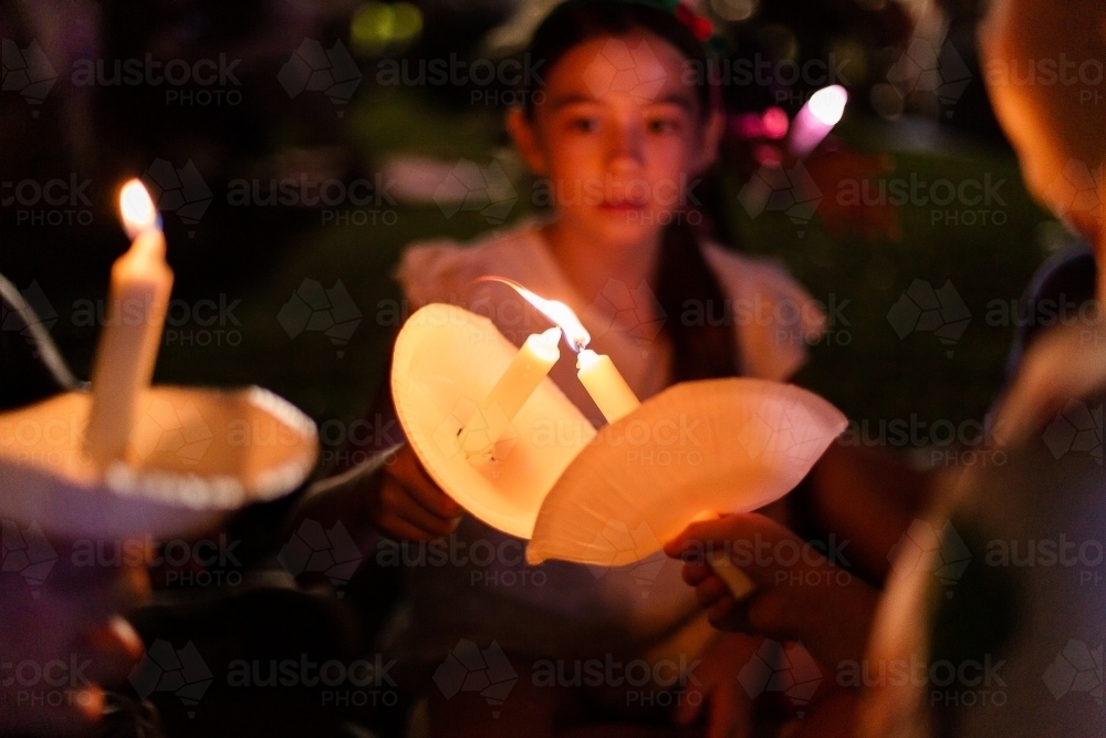 Image of lighting candles at carols by candlelight and catching drips ...