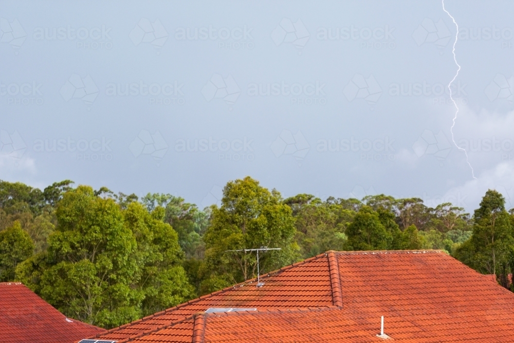 Image of Lightning bolt strike against storm clouds about suburban ...