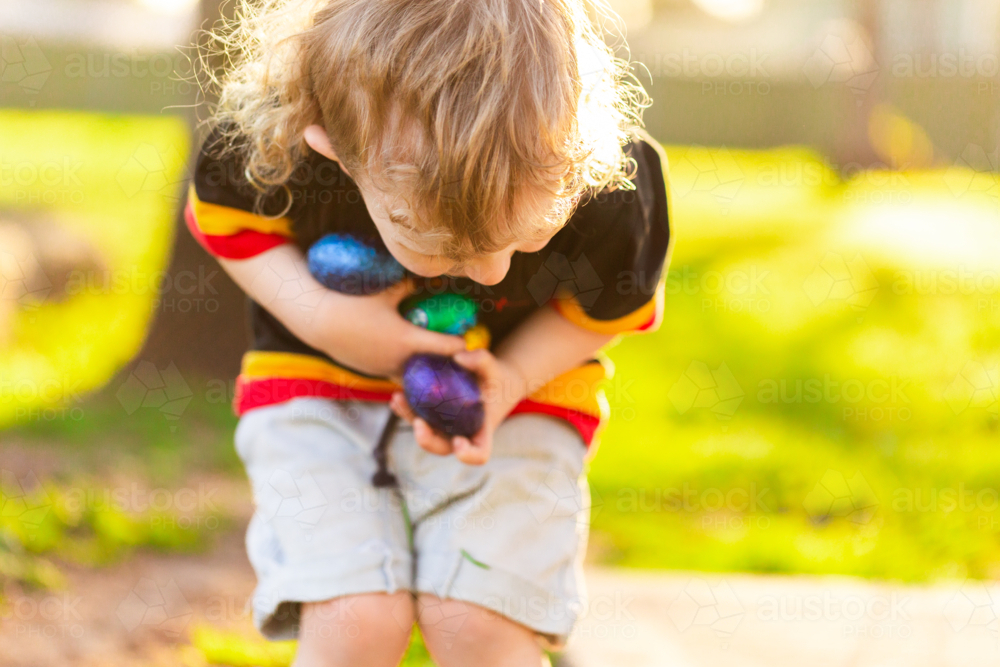 Image of Little Aboriginal Australian boy holding foil wrapped ...