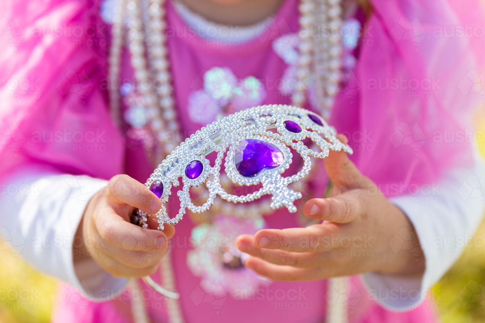 Image of Little girl child wearing pink princess dressups holding crown ...
