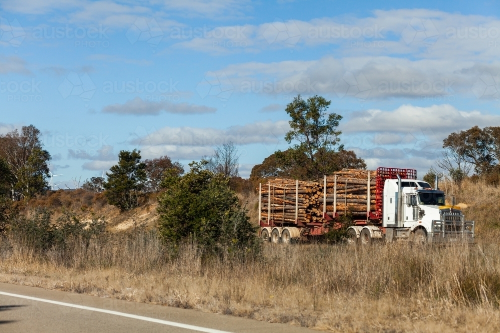 Image of Logging truck transporting logs on highway - Austockphoto