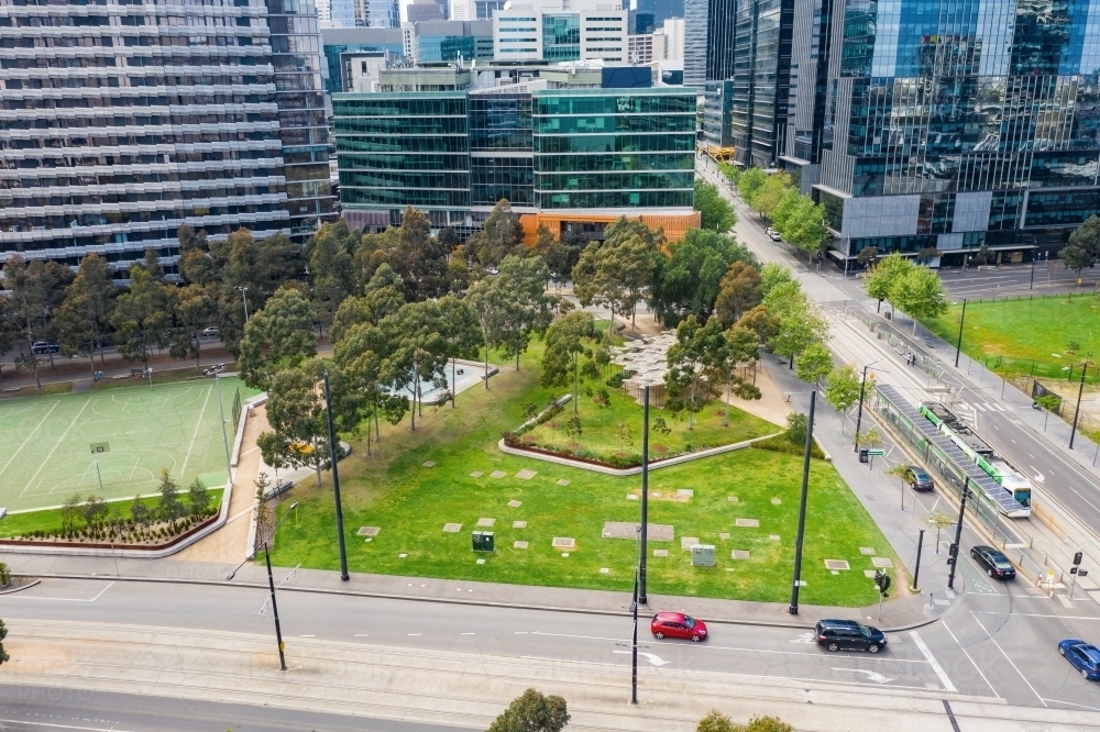Image of Looking down a corner city park surrounded by high rise ...