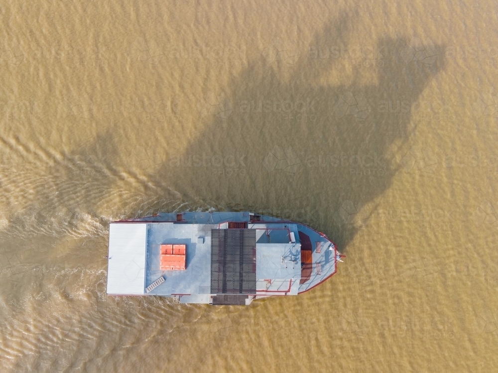 Image of Looking down on a paddle steamer and its long shadow on a wide ...