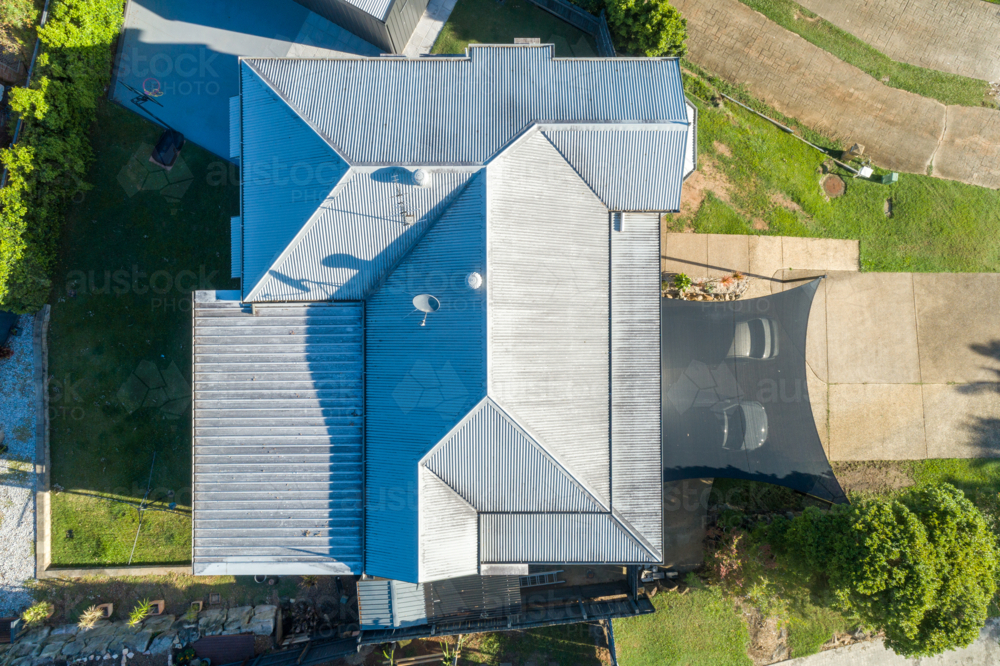 Image of Looking down on house with corrugated metal roof. - Austockphoto