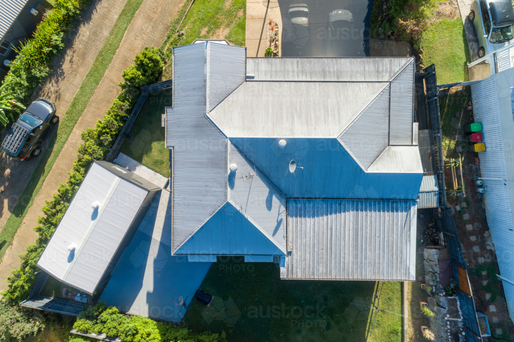Image of Looking down on house with corrugated metal roof. - Austockphoto