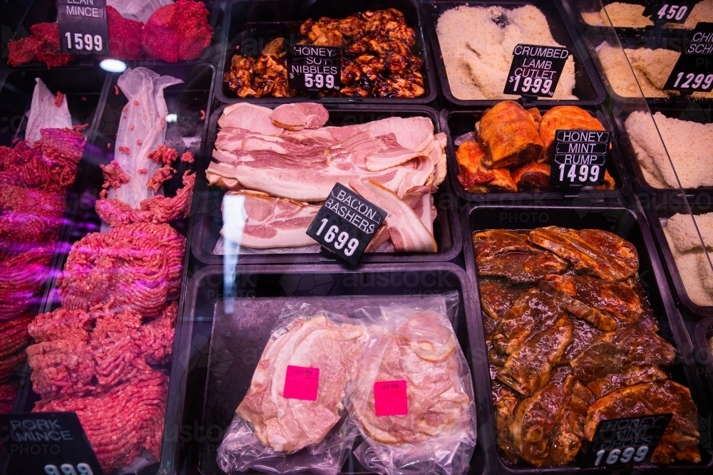 Image of looking into a butcher shop cabinet with meat including bacon ...