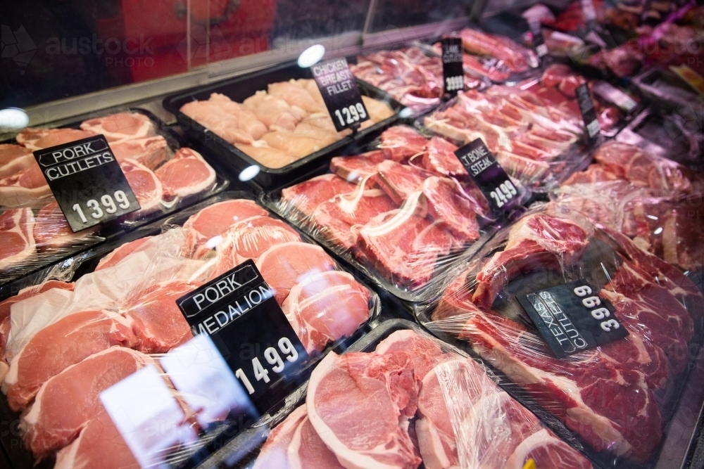 Image of looking into a butcher shop cabinet with pork and steak ...