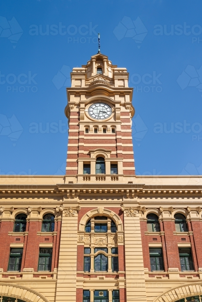 Image of Looking up at a tall clock tower with intricate brickwork ...