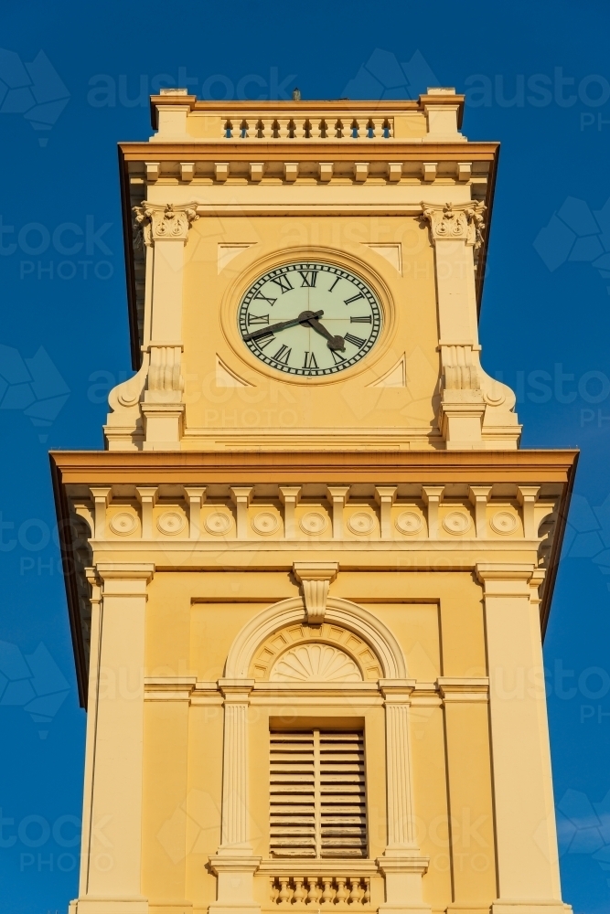 Image of Looking up at an historic clock tower bathed in afternoon ...