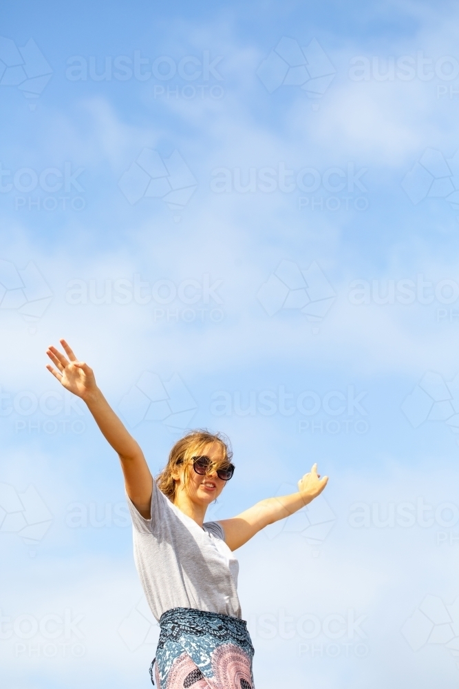 Image of Looking up at girl with arms out - Austockphoto