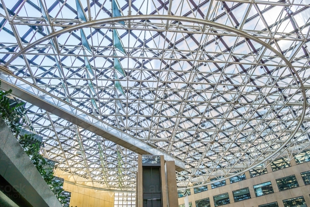 Image of Looking up at the ceiling of a large steel and glass atrium ...