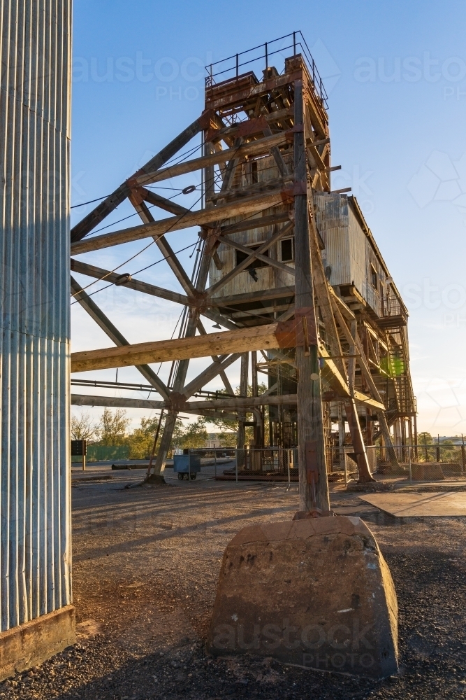 Image of Looking up at the remains of an old mining poppet head against ...