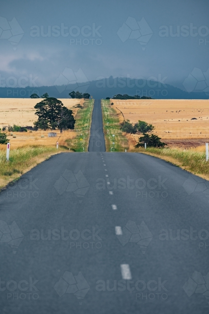 Image of Low angled view of a bitumen road leading into heavy rain ...
