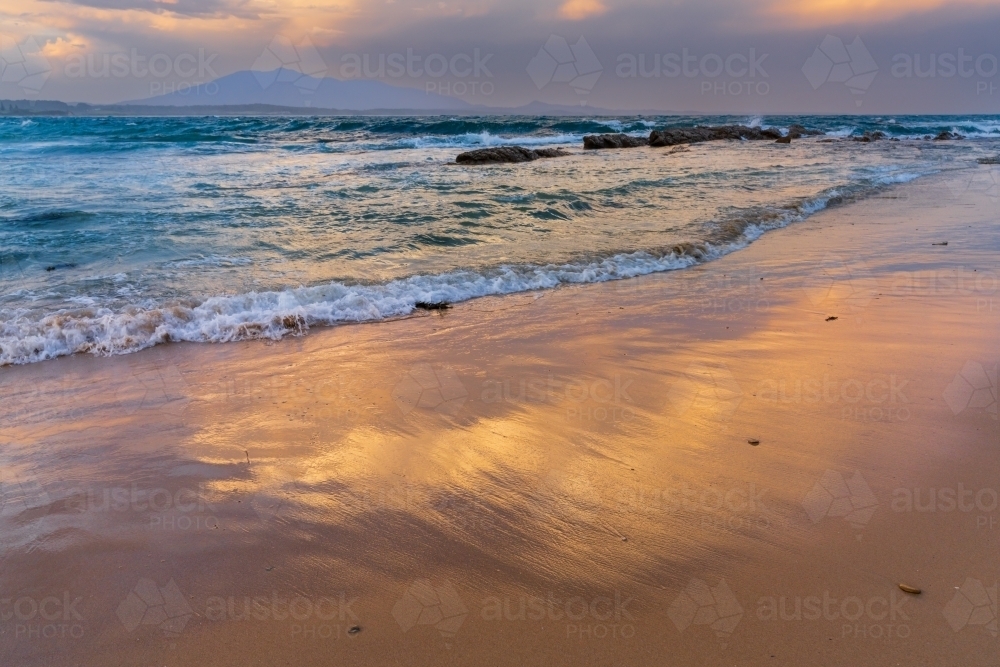Image of Low angled view of a dramatic sunset sky over the ocean ...