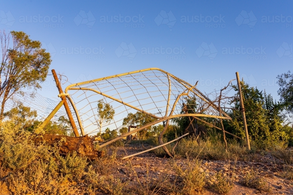 Image of Low angled view of a twisted steel gate in an outback ...