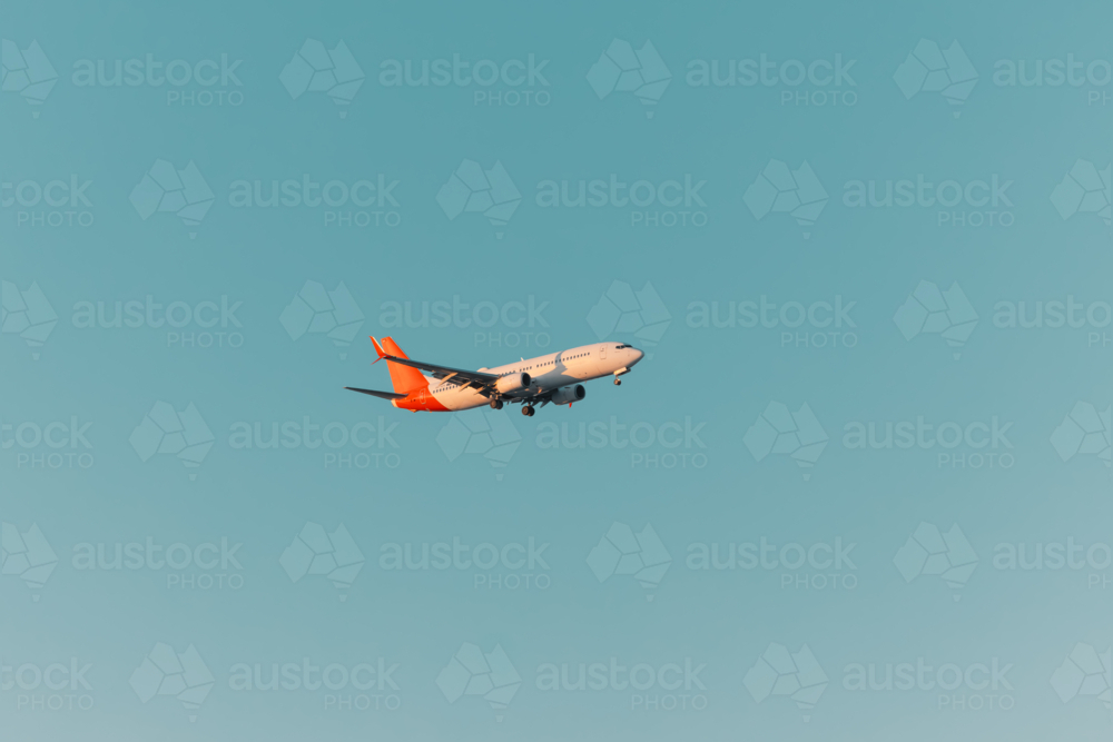 Image of Low flying airplane coming isolated in clear blue sky ...