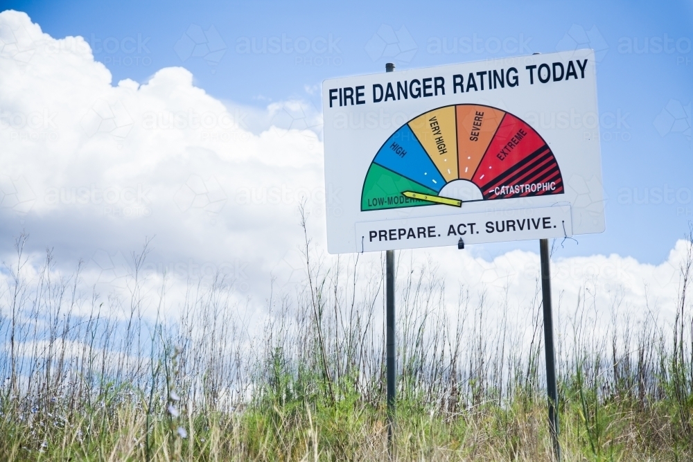 Image of Low moderate fire danger rating on sign in long grass ...