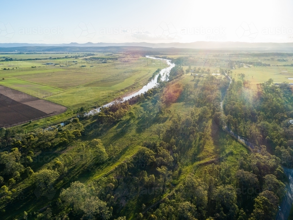 Image of Lush green farmland and winding country road with cliff down ...