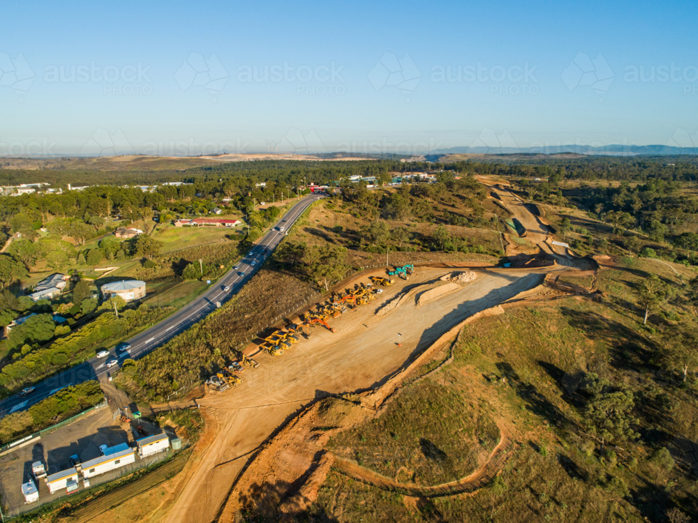 Image of Machinery on worksite lined up in morning light ready to ...