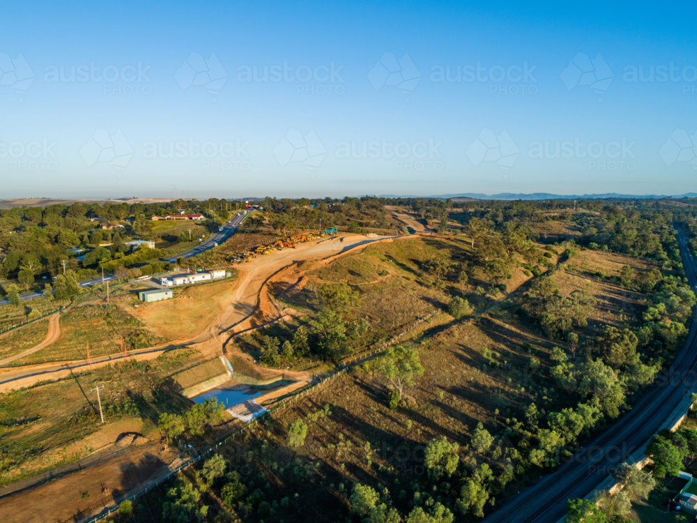 Image of Machinery on worksite lined up in morning light ready to ...