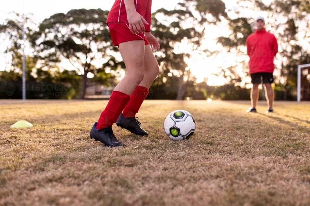 Image of Male coach standing and teaching tween girl as she trains for ...