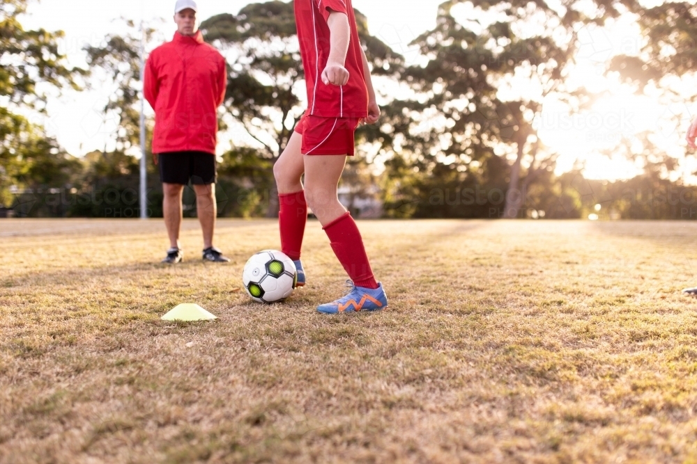 Image of Male coach standing and teaching tween girls as they train for ...