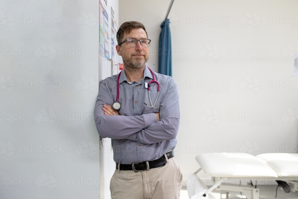 Image of Male doctor with stethoscope around his neck standing while ...
