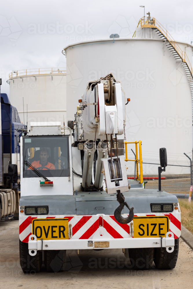 Image of Male worker driving the white cherry picker truck. - Austockphoto