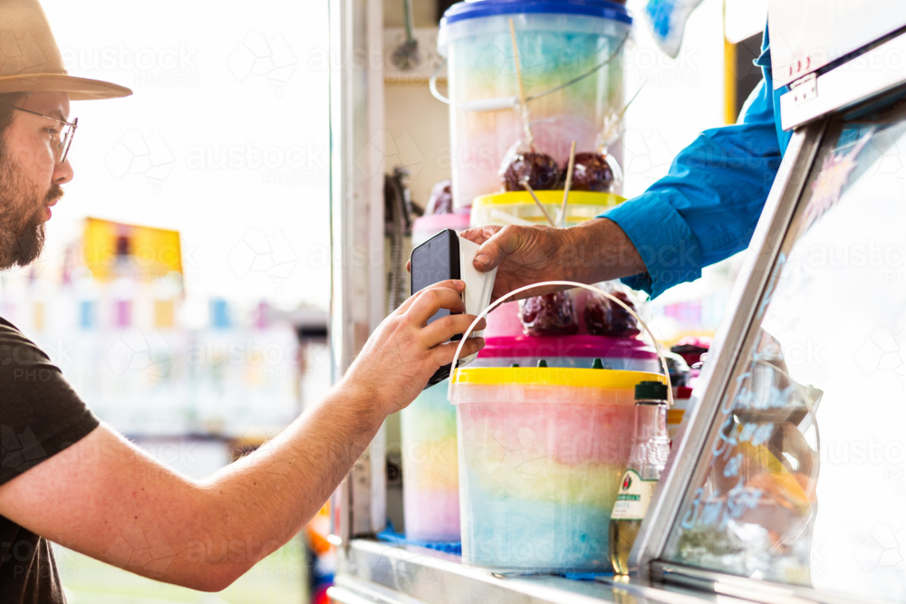 Image of Man buying bucket of fairy floss from sideshow alley stall at ...