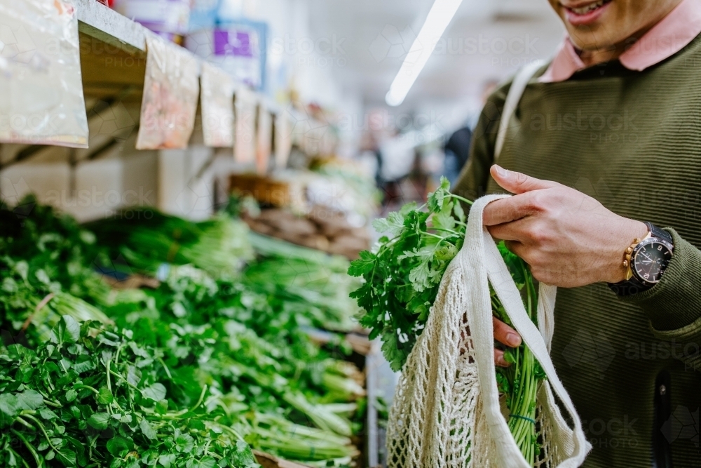 Image of Man buying fresh produce at supermarket - Austockphoto