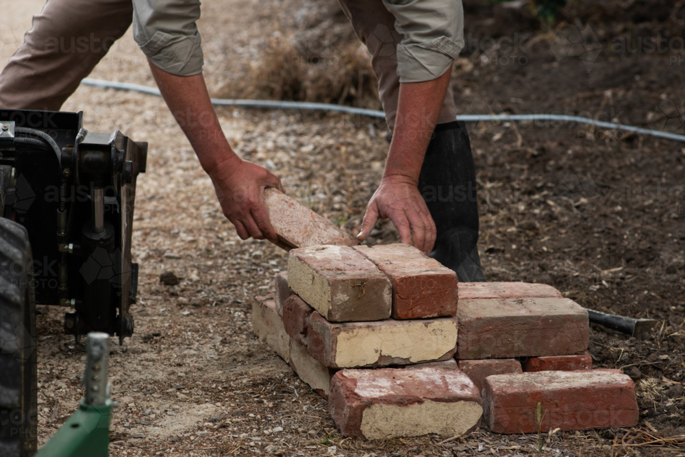 Image of man doing landscaping work - Austockphoto