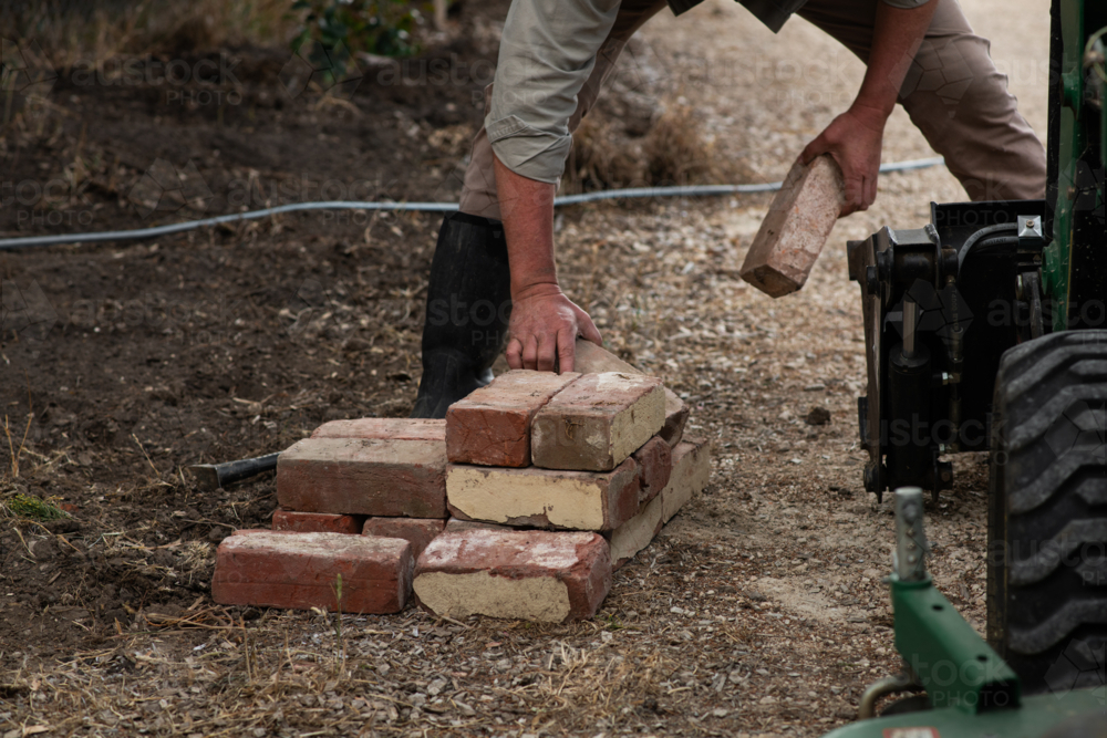 Image of man doing landscaping work - Austockphoto