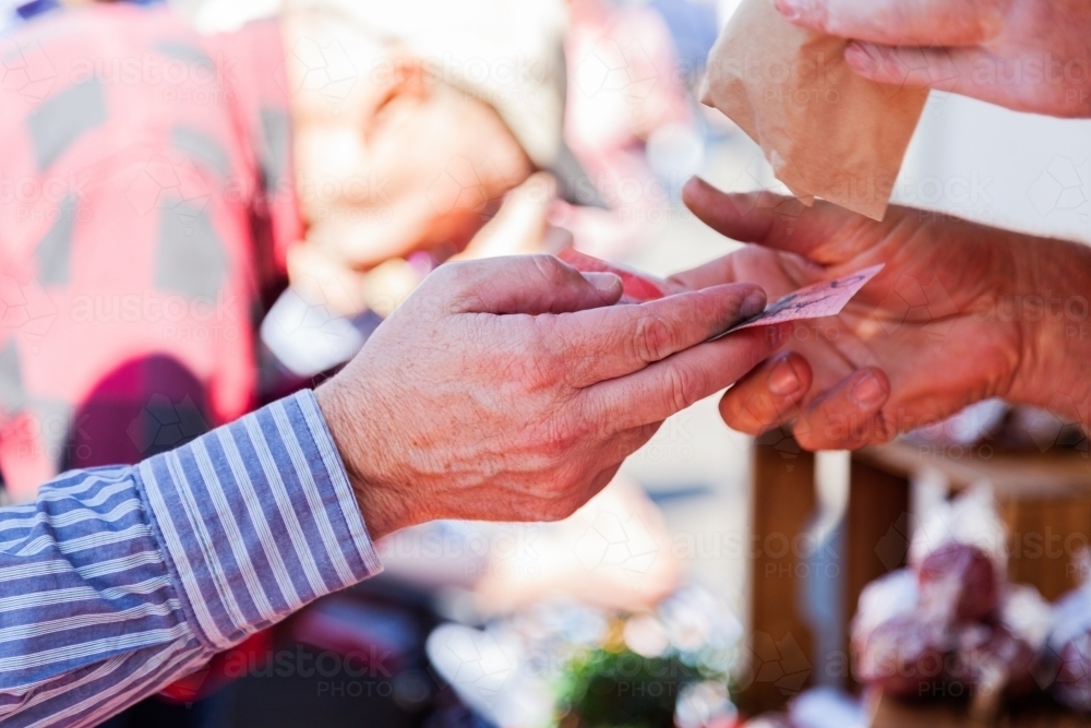 Image of Man handing over twenty dollar note making cash payment ...