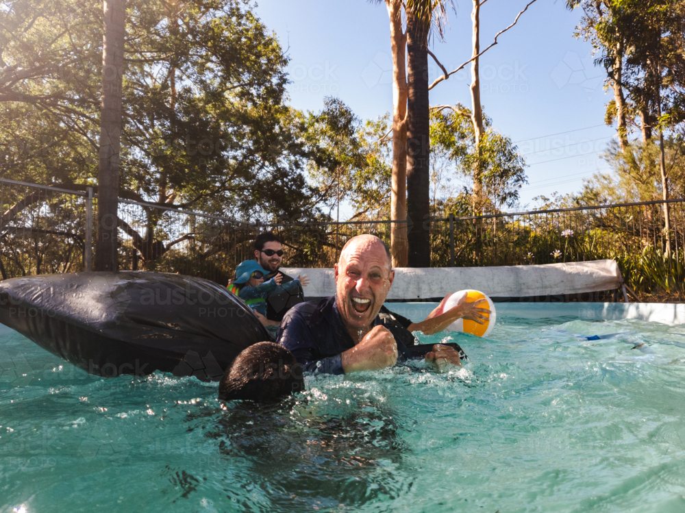Image of Man in his fifties playing with kids and grandchild in ...