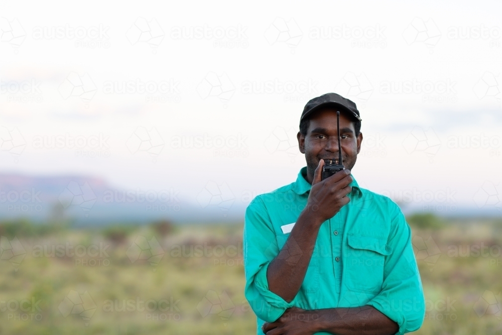 Image of Man in the outback taking on two-way-radio - Austockphoto