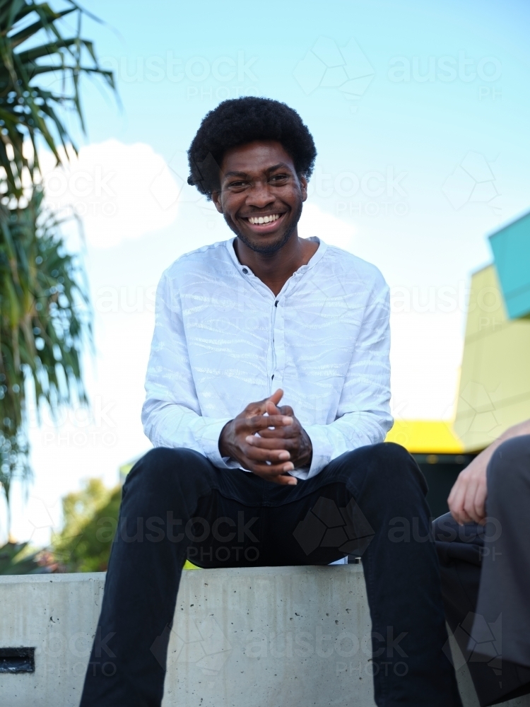 Image of Man sitting on a concrete bench outside - Austockphoto