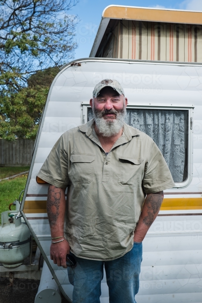 Image of Man stands in front of his caravan. - Austockphoto