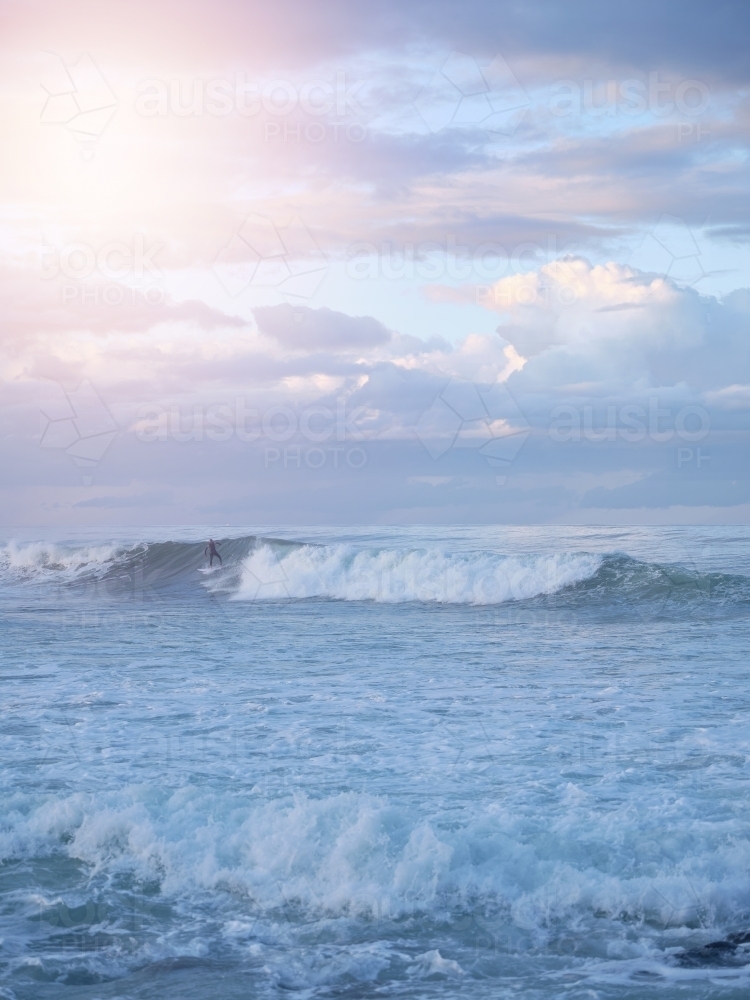 Image of Man surfing over big waves on the beach - Austockphoto