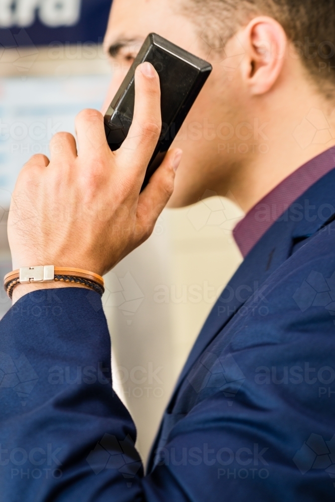Image of man using payphone - Austockphoto