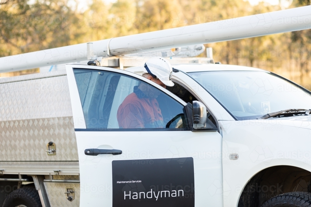 Image of man with hard hat getting into handyman maintenance services ...